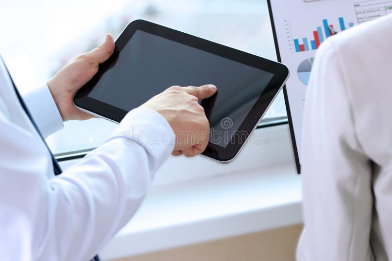 Business Colleagues Working and Analyzing Financial Graphs on a Digital ...