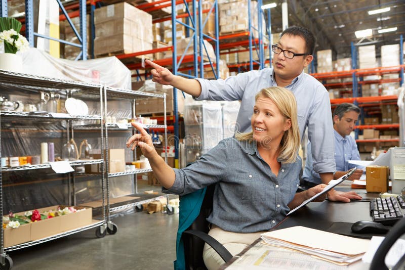 Business Colleagues Working at Desk in Warehouse Stock Image - Image of ...