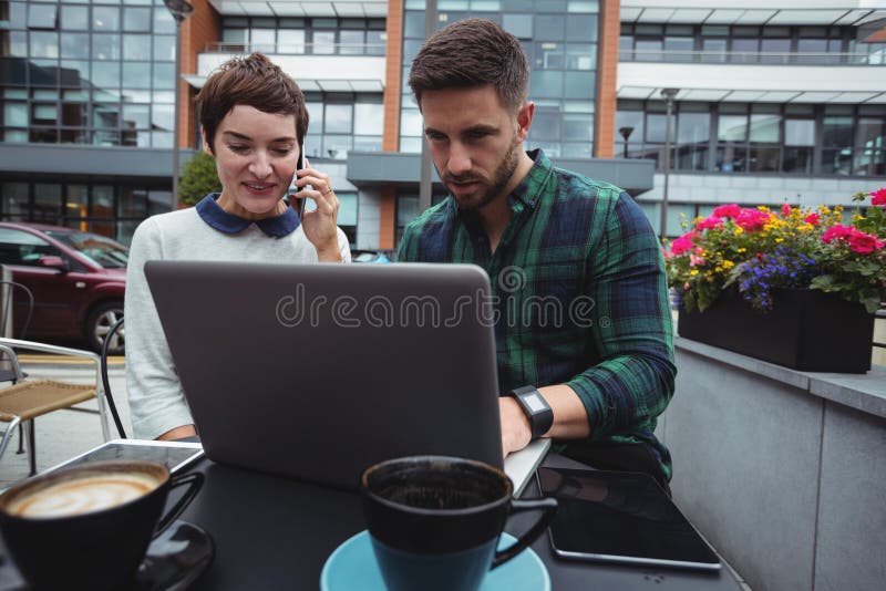 Business Colleagues Working while Having Coffee in Cafeteria Stock ...