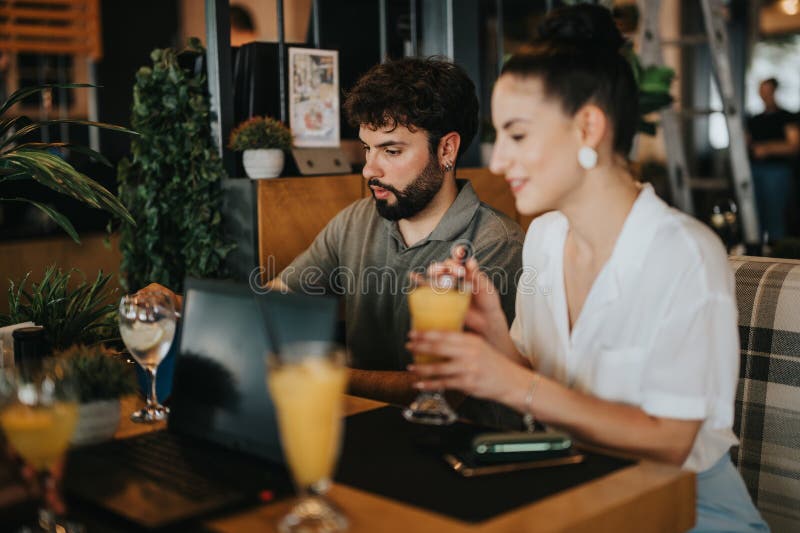 Business Colleagues in a Meeting at a Coffee Bar with Laptop and Drinks ...
