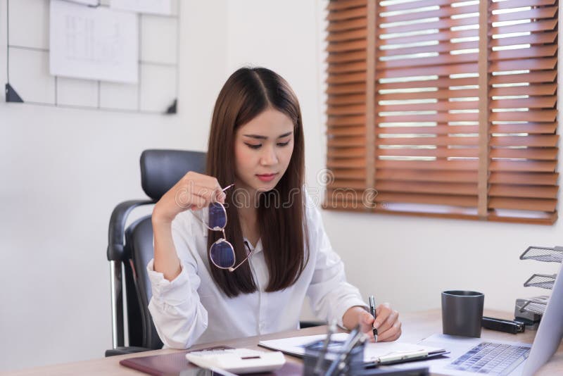 Business Concept, Businesswoman is Hold Glasses while Reading and ... Business Concept, Businesswoman is Hold Glasses while Reading and ...