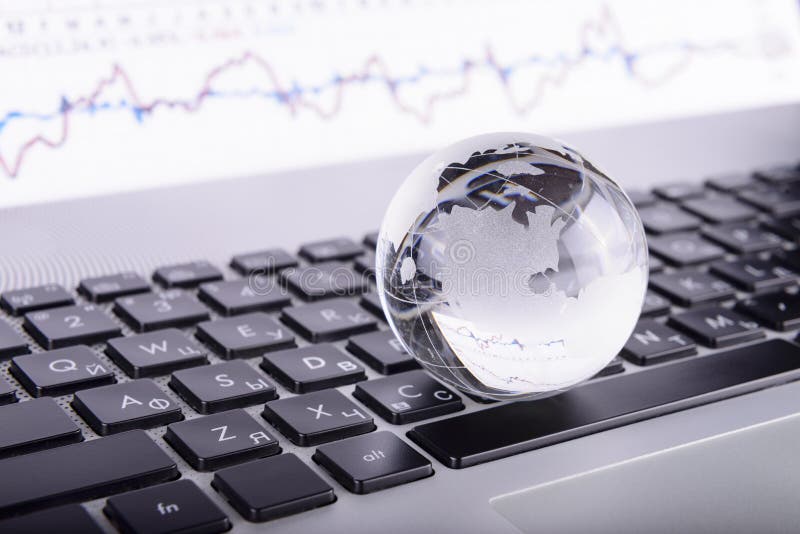 Business Concept of Glass Globe on a Laptop Keyboard Stock Photo ...