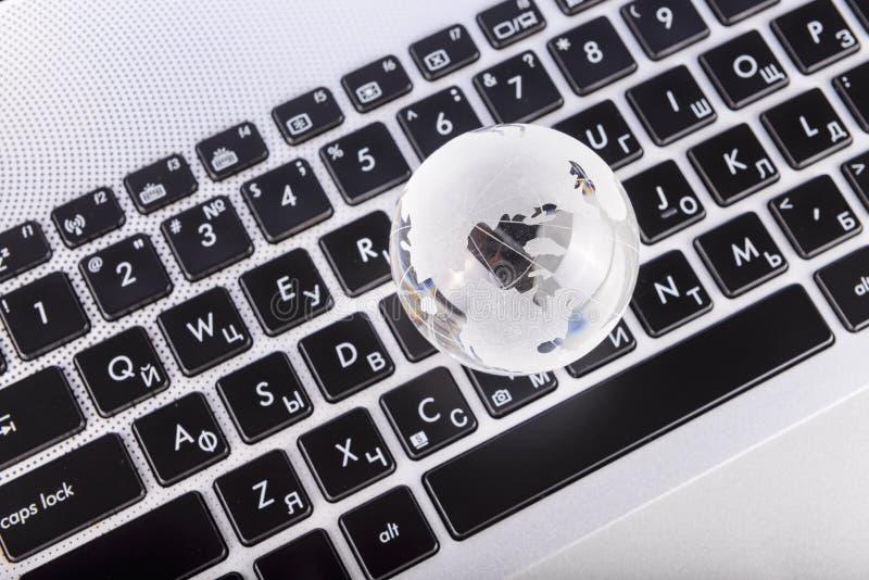Business Concept of Glass Globe on a Laptop Keyboard Stock Photo ...