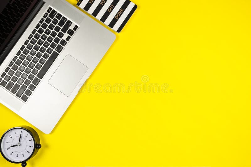 Business Concept of Laptop, Clock and Small Notepad on Bright Yellow ...