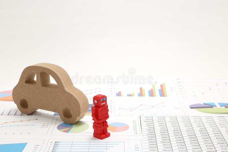 Business Concept with Miniature Robot, Car Model, and Financial Graphs ...