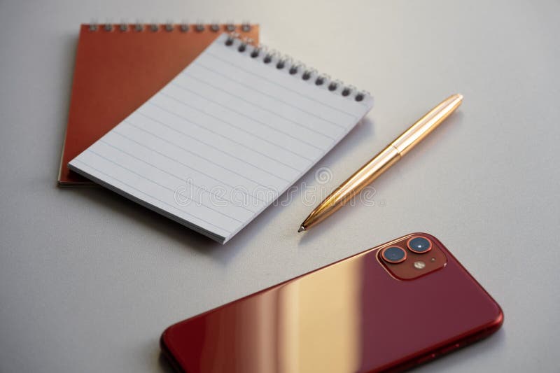 Business Concept. Smartphone, Notepads and Golden Pen on the Table ...