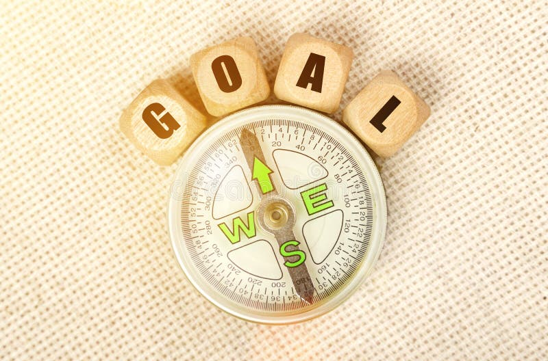 On the Table is a Compass and Cubes with the Inscription - GOAL Stock ...