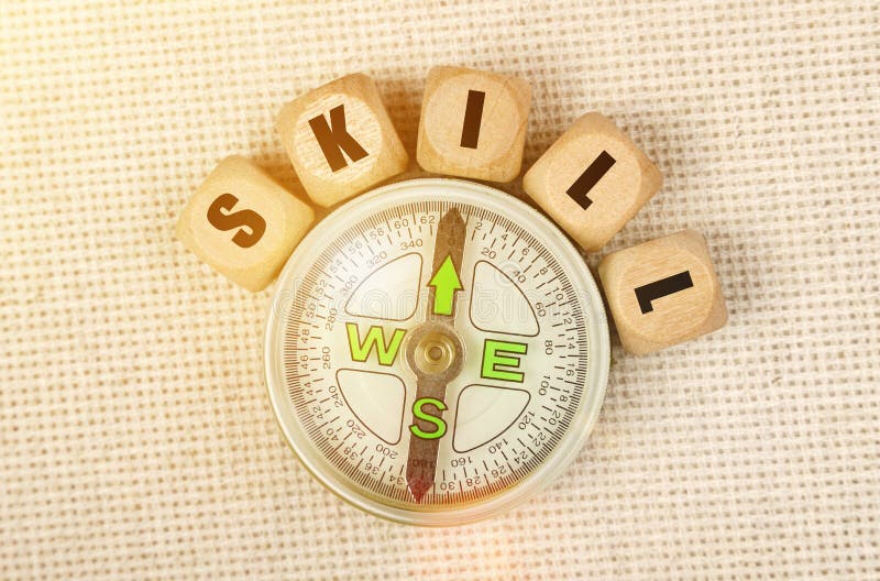 On the Table is a Compass and Cubes with the Inscription - SKILL Stock ...