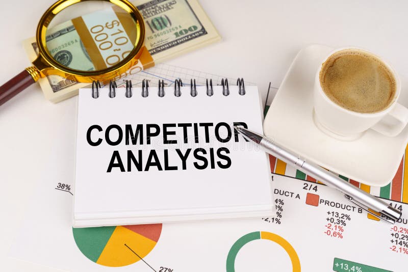 On the Table is a Cup of Coffee, Money, Business Charts and a Notepad ...