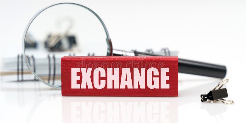 On the Table is a Notebook, a Magnifying Glass and a Tablet with the ...