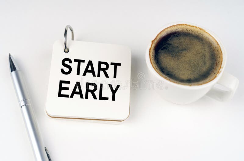 On a White Surface, a Cup of Coffee, a Pen and a Notepad with the ...