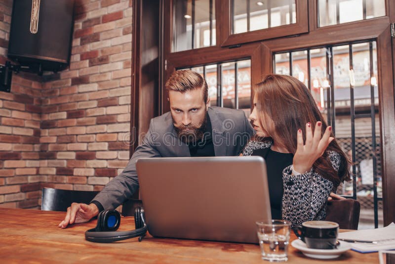 Business Couple Having Discussion about Job, Using Laptop Computer ...