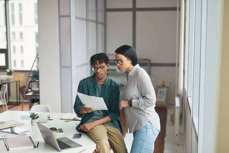 Business Couple Reading a Document Stock Photo - Image of brainstorming ...