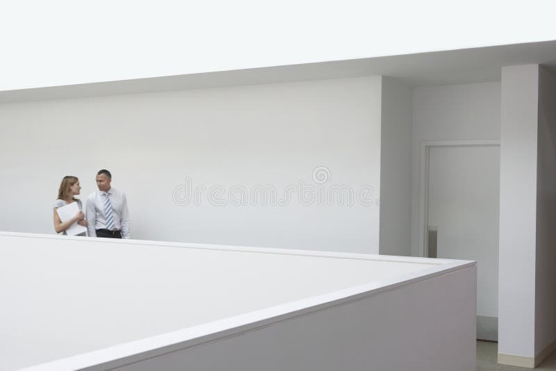 Business Couple Walking through Hallway Stock Photo - Image of ...