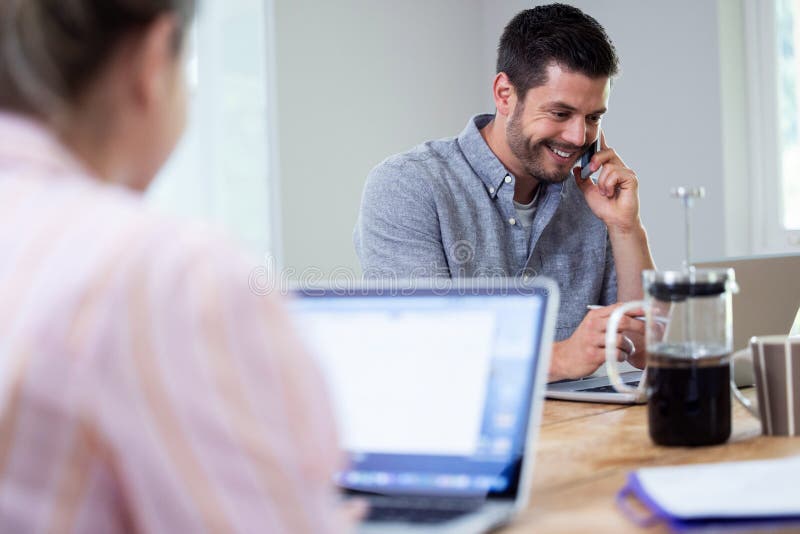 Business Couple Working from Home Sitting at Table during Pandemic ...