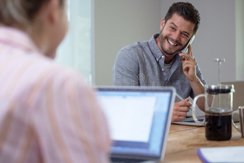 Business Couple Working from Home Sitting at Table during Pandemic ...