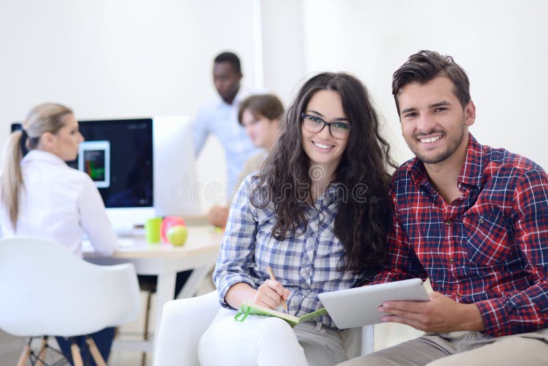 Business Couple Working Together on Project at Modern Startup Office ...
