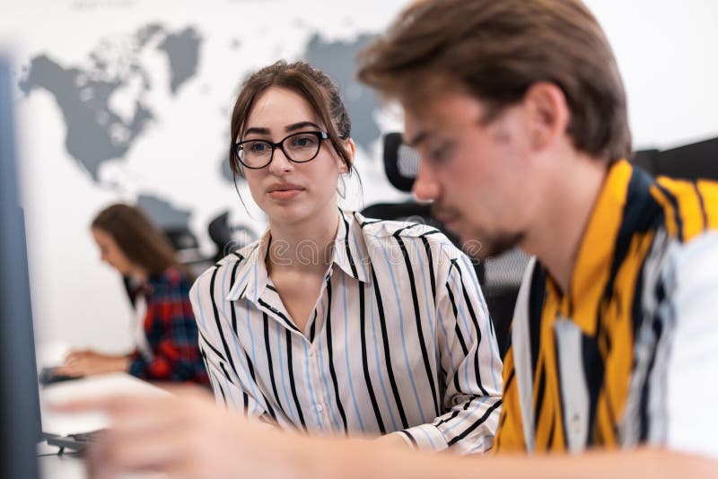 Business Couple Working Together on Project Using Tablet and Desktop ...