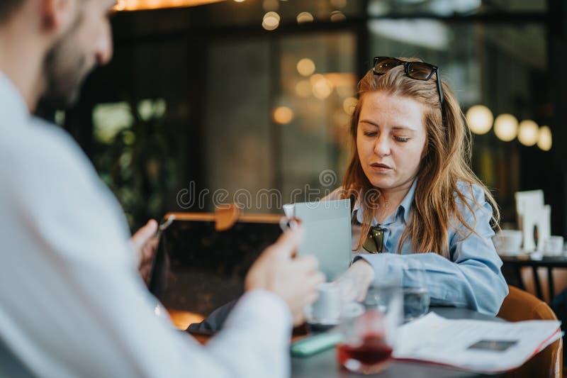 Business Dialogue between Colleagues at a Modern Cafe Setting Stock ...