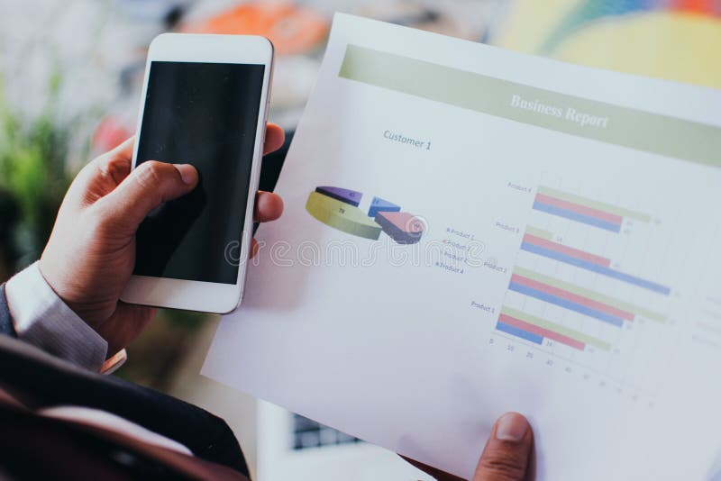 Business Documents on Office Table with Smartphone and Graph Financial ...