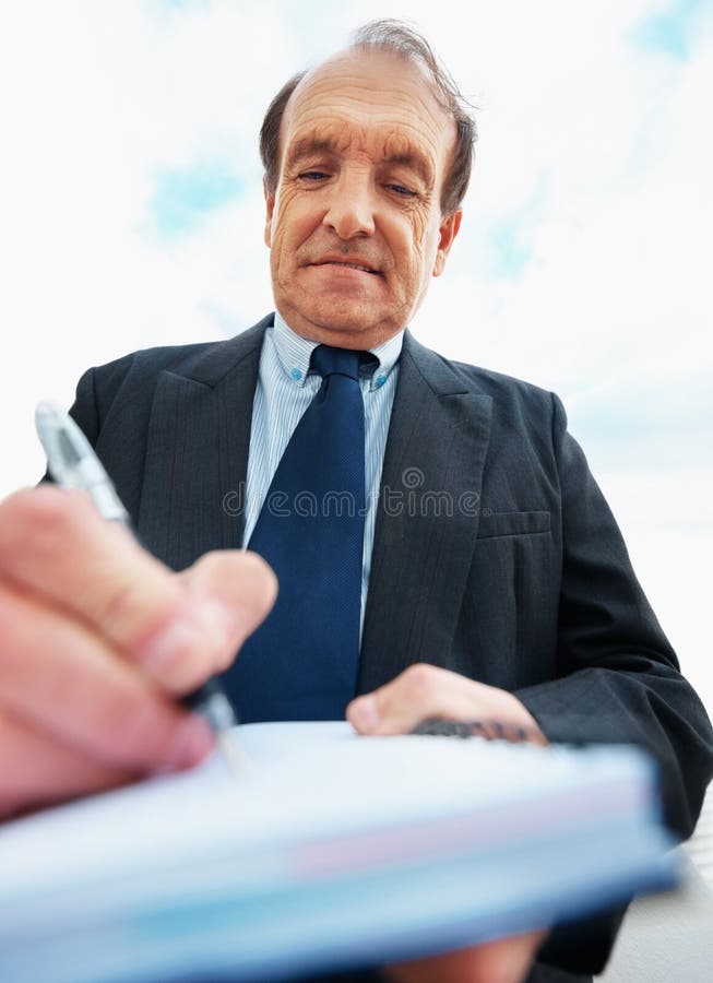 Business Executive Taking Notes on a Book Outdoors Stock Photo - Image ...