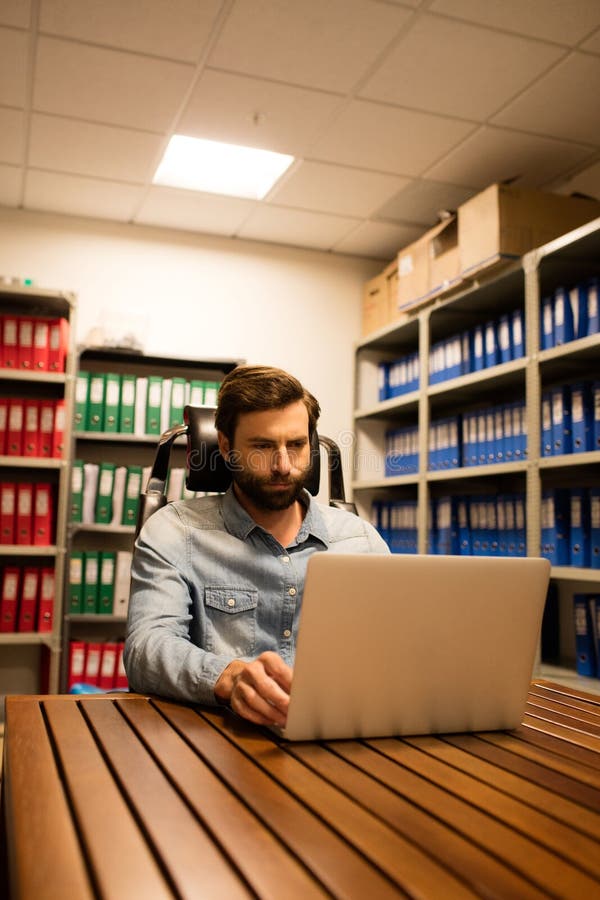 Business Executive Using Laptop in File Storage Room Stock Image ...