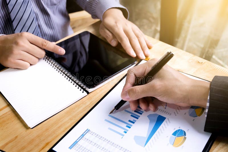 Business Executives Discussing Documents and Ideas at Meeting in a ...