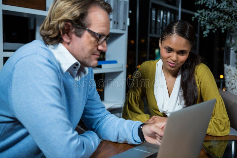 Business Executives Discussing Over Laptop Stock Image - Image of ...