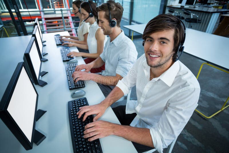 Business Executives with Headsets Using Computer Stock Photo - Image of ...