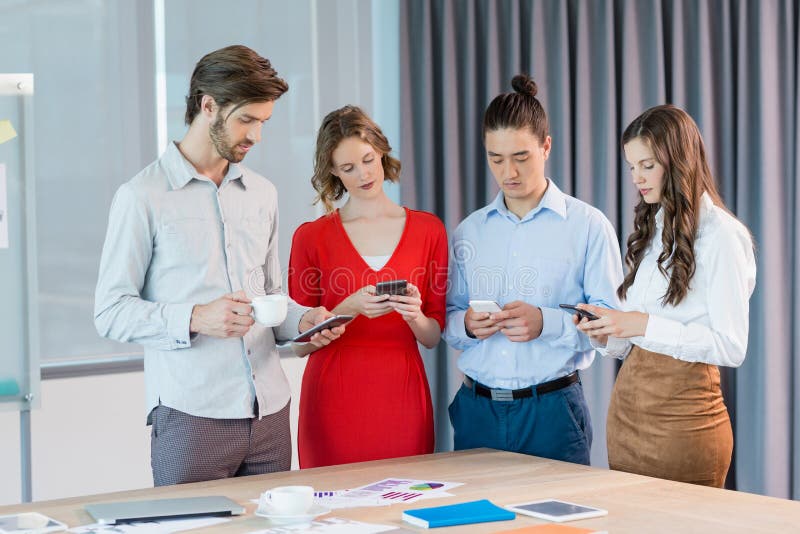 Business Executives Using Mobile Phones in Conference Room Stock Image ...