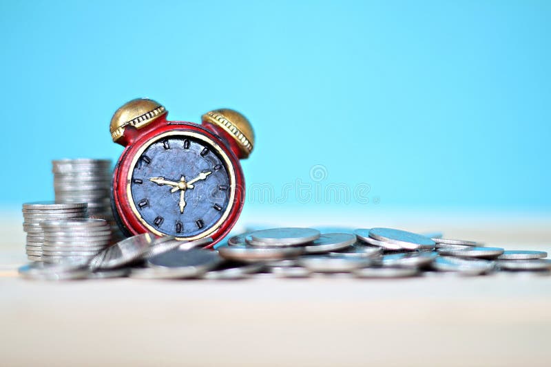 Miniature Clock and Coins Stack on Desk Table Stock Photo - Image of ...