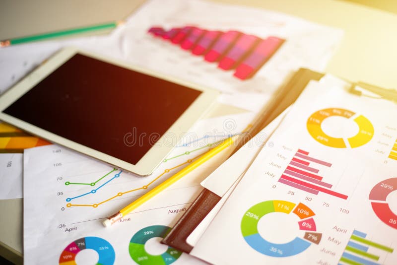 Business Financial Chart and Graphy Report on Table with Digital Tablet ...