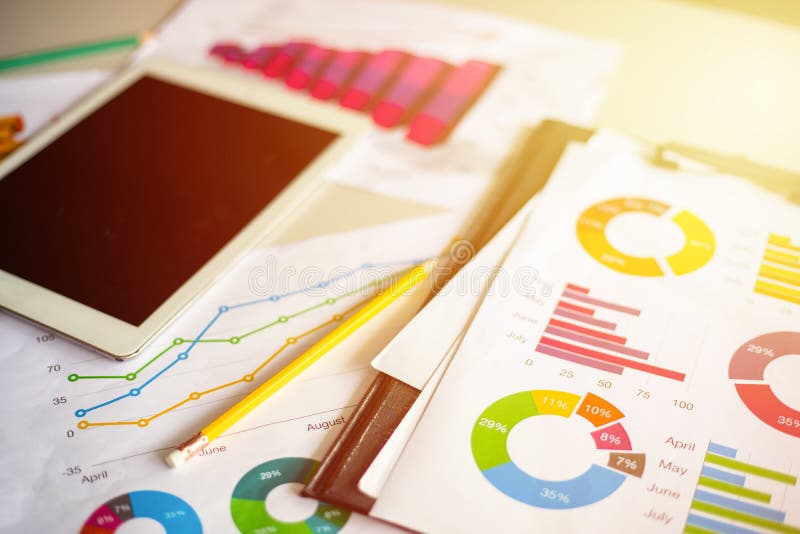 Business Financial Chart and Graphy Report on Table with Digital Tablet ...