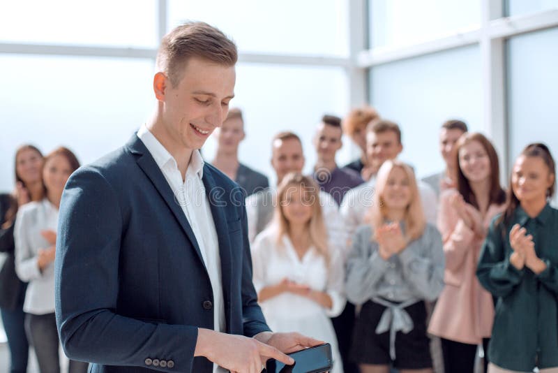 Business Guy with Smartphone Standing in Front of a Group of Young ...