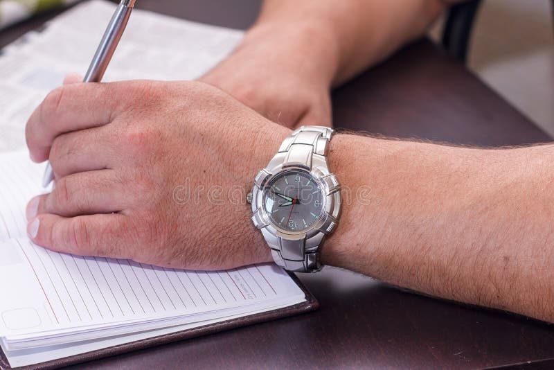 Business Hand with the Clock, Holding Pen and Notebook Stock Photo ...