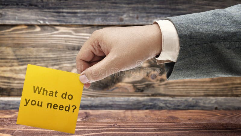 Business Hand Holding a Note with What Do You Need Text Stock Photo ...