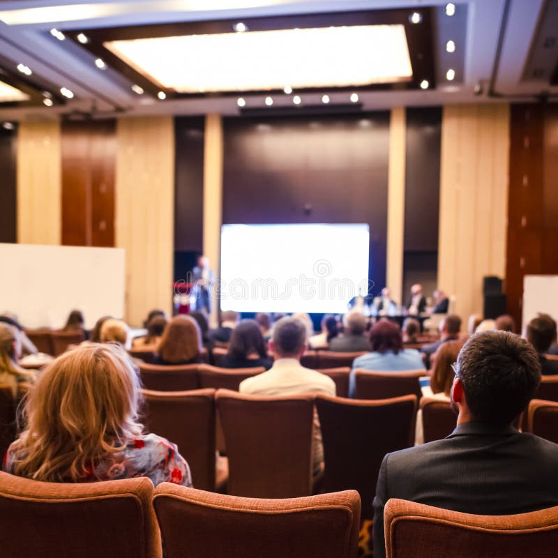 Host Speaking in Front of the Group of Business People during a ...