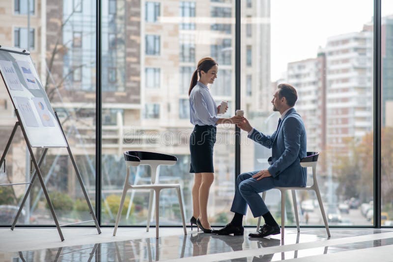 Business Lady Bringing Takeaway Coffee To Her Business Partner Stock ...
