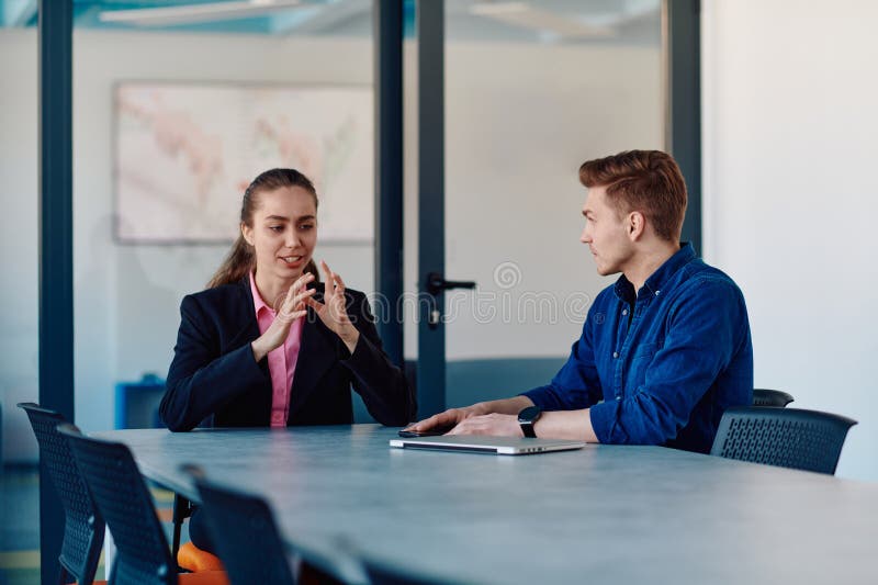 A Business Leader in a Suit Conversing with Her Worker in the it ...