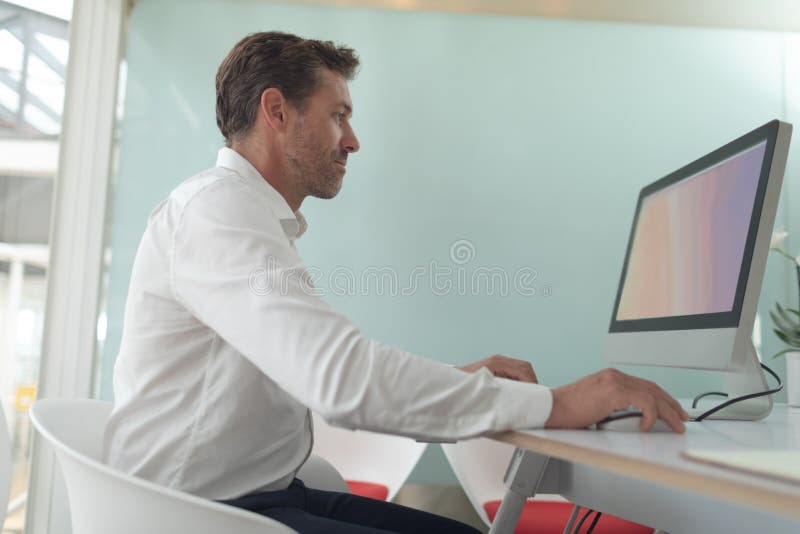 Business Male Executive Working on Computer at Desk in a Modern Office ...