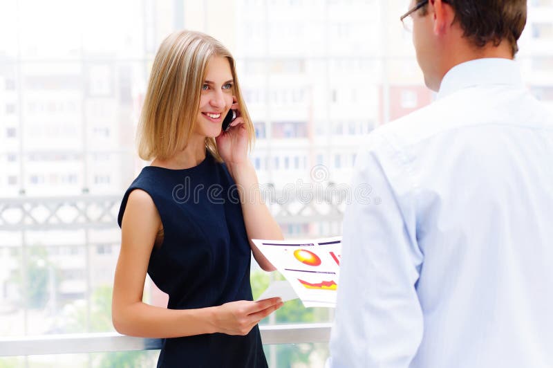 Business Man and Business Woman Discuss Reports Stock Photo - Image of ...
