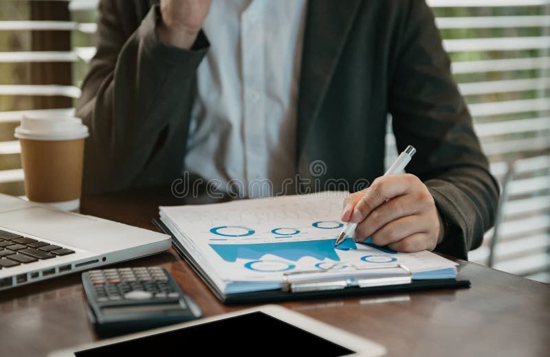 Business Man Calculate and Analyzing Graph Document Financial with ... Business Man Calculate and Analyzing Graph Document Financial with ...