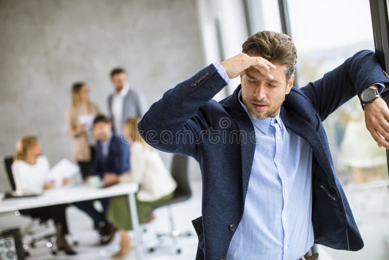 Business Man Feeling Exhausted and Stand at His Working Place in Office ...
