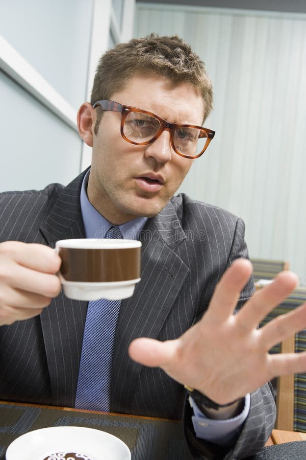 Business Man Gesturing while Having Coffee Stock Image - Image of ...