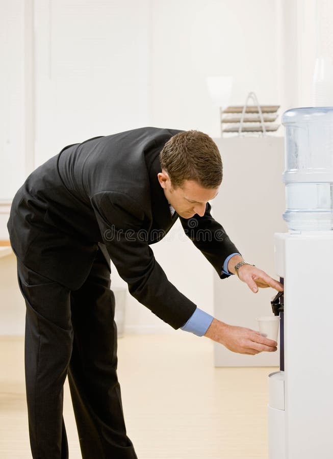 Business People Interacting at a Water Cooler Stock Image - Image of ...