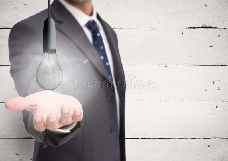 Business Man Hand Out with Glowing Lightbulb Against White Wood Panel ...