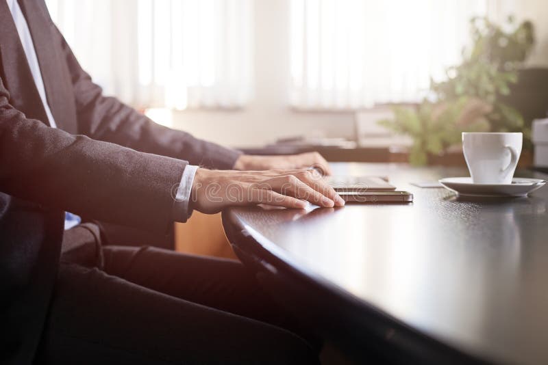 Business Man Hands on a Table with Tablet, Phone and Cup of Coffee in a ...