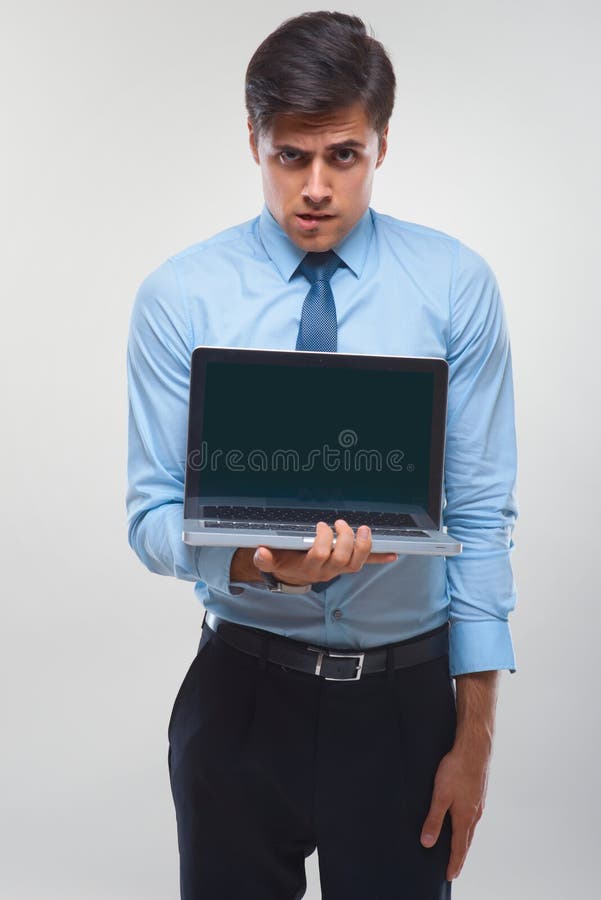 Business Man Holding a Laptop Against a White Background Stock Photo ...