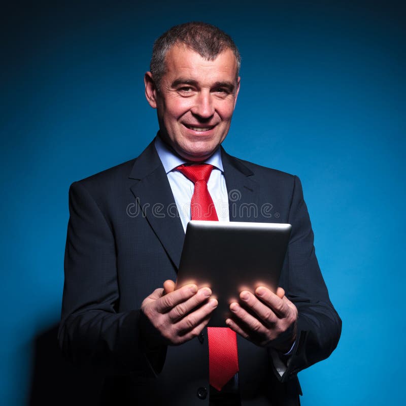 Business Man Holding a Tablet Pad and Smiles Stock Photo - Image of ...