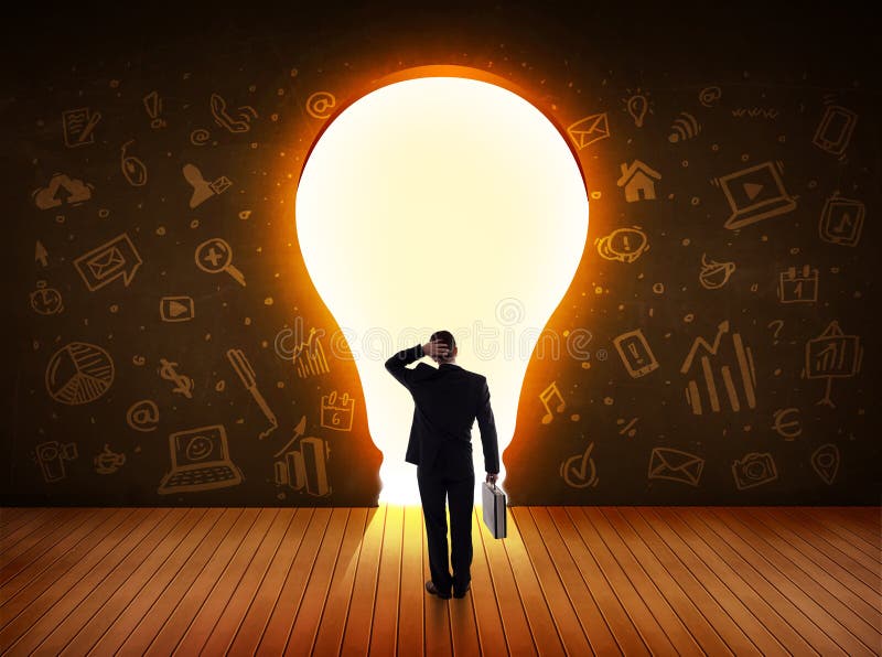 Business Man Looking at Bright Light Bulb in the Wall Stock Image ...